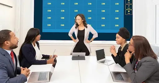 Office team engaged in an online Jeopardy game on a large screen during ...