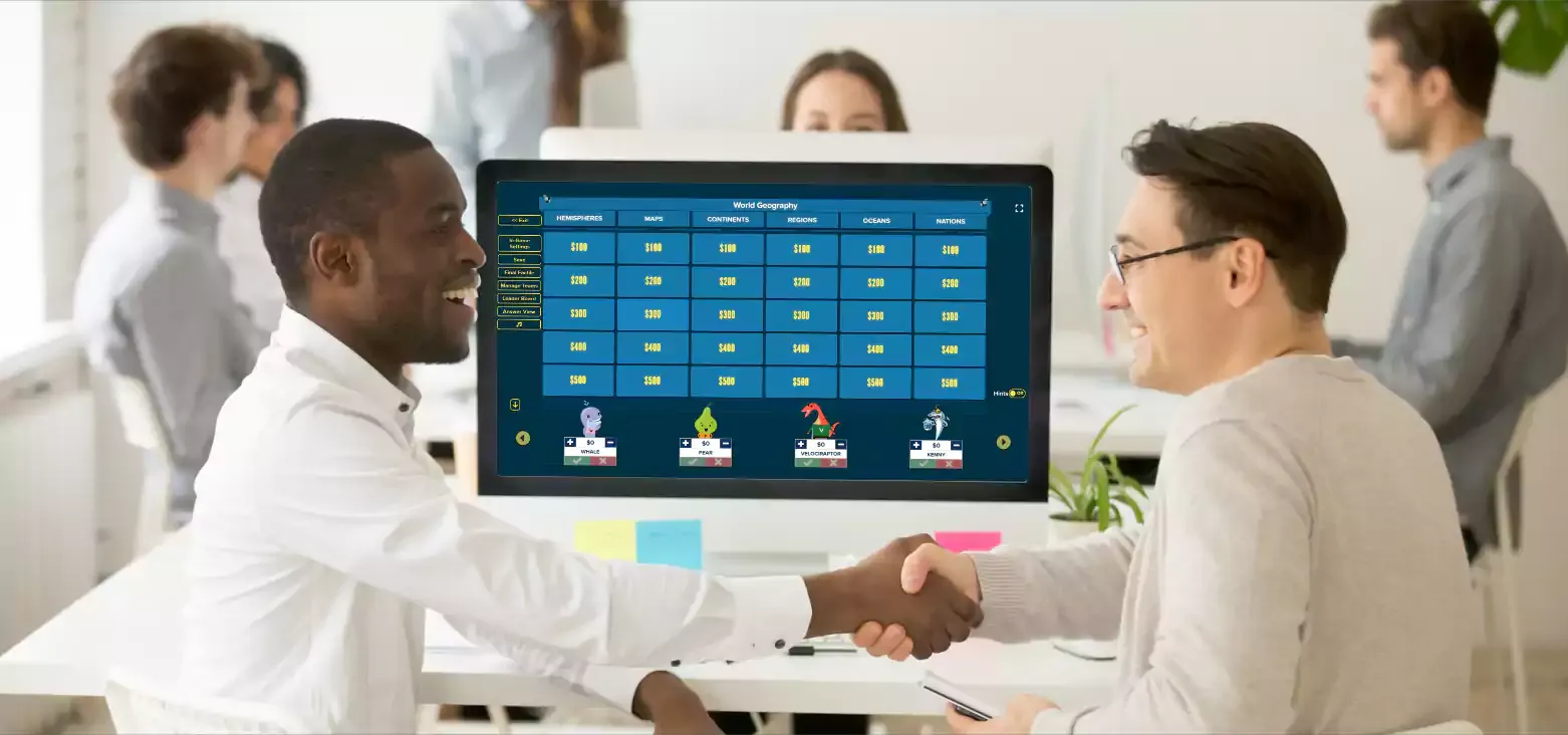 Two coworkers smile and shake hands at a desk, playing playfactile ...