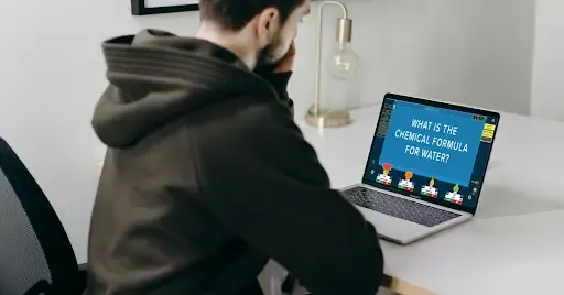 Student studying alone with an educational quiz displayed on a laptop ...